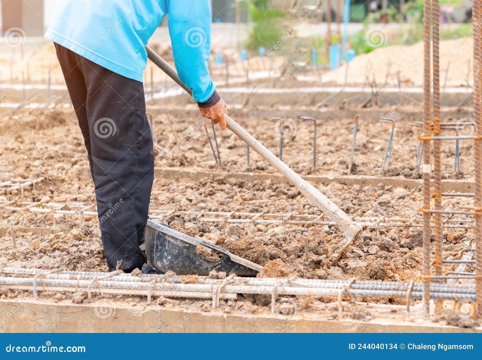 A Worker Digging the Ground with Spade in Construction Site Stock Photo ...
