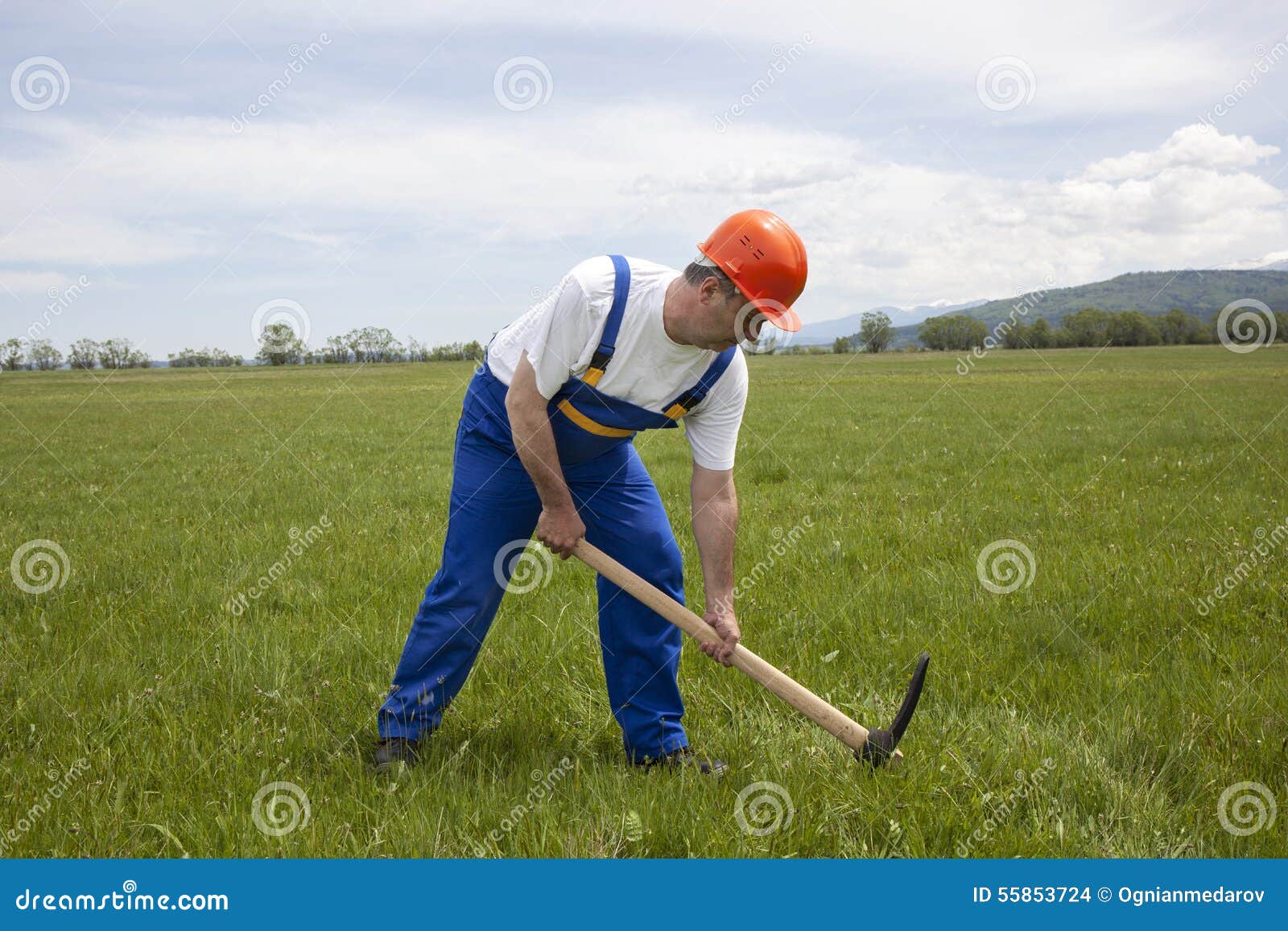 Worker is Digging by Pickaxe on a Green Field Stock Photo - Image of ...