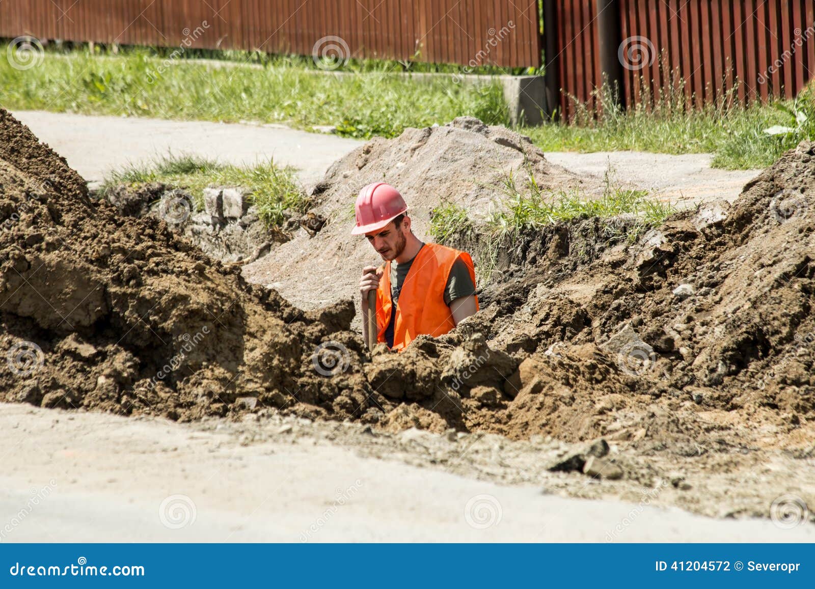 Worker Digging Holes On A Sloping Area To Put Pillars To Build House ...