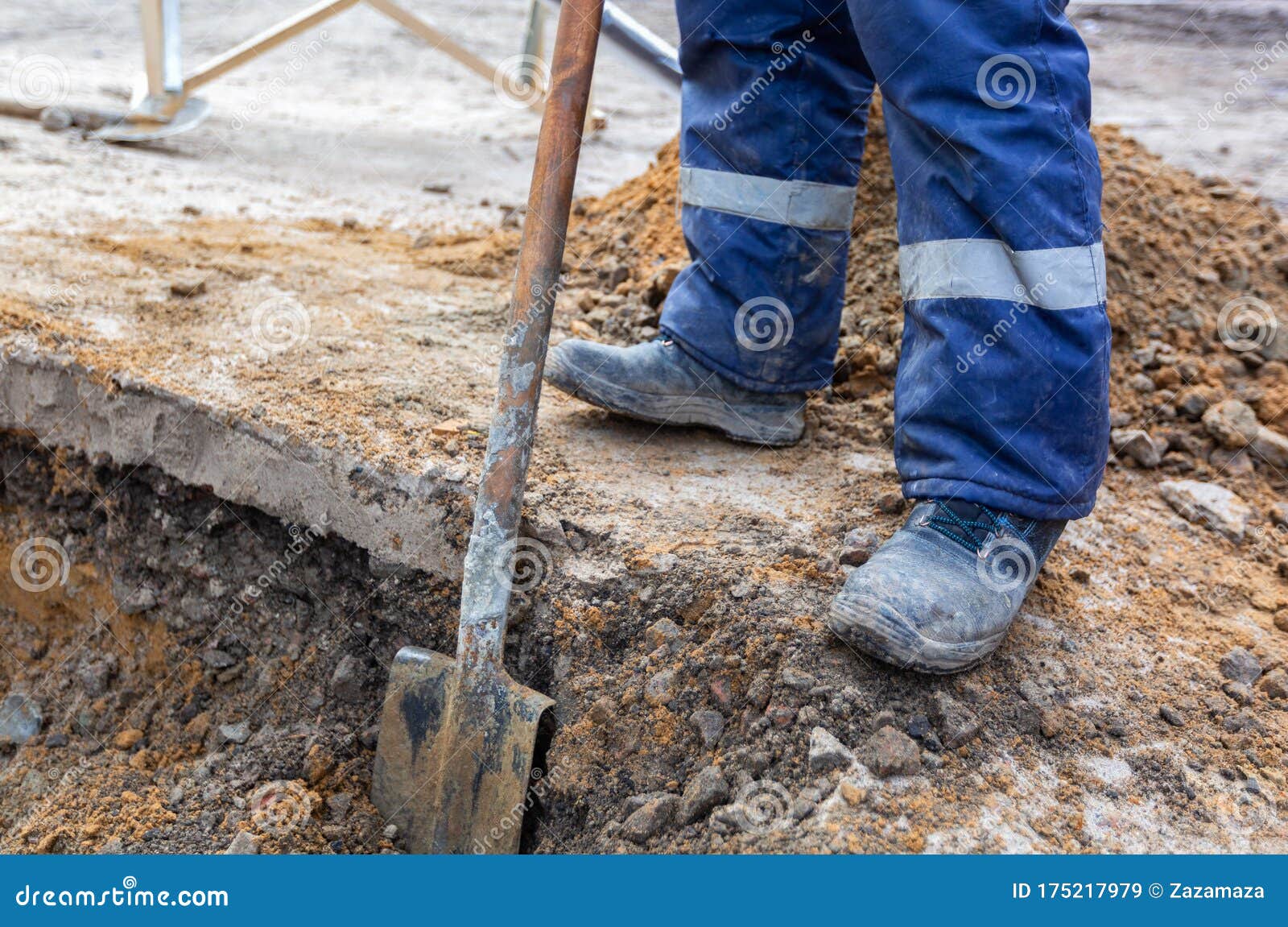 Worker in Dirty Uniform and Shoes with Shovel is Digging a Pit on ...