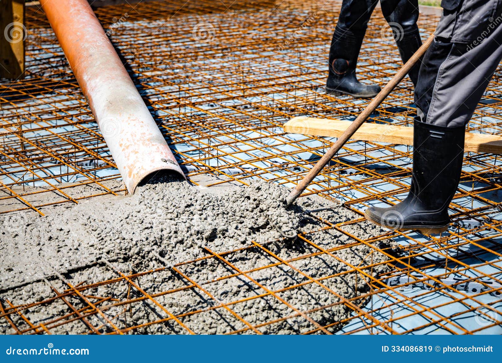 Worker Distributing Concrete Onto Rebar Framework for Slab Foundation ...