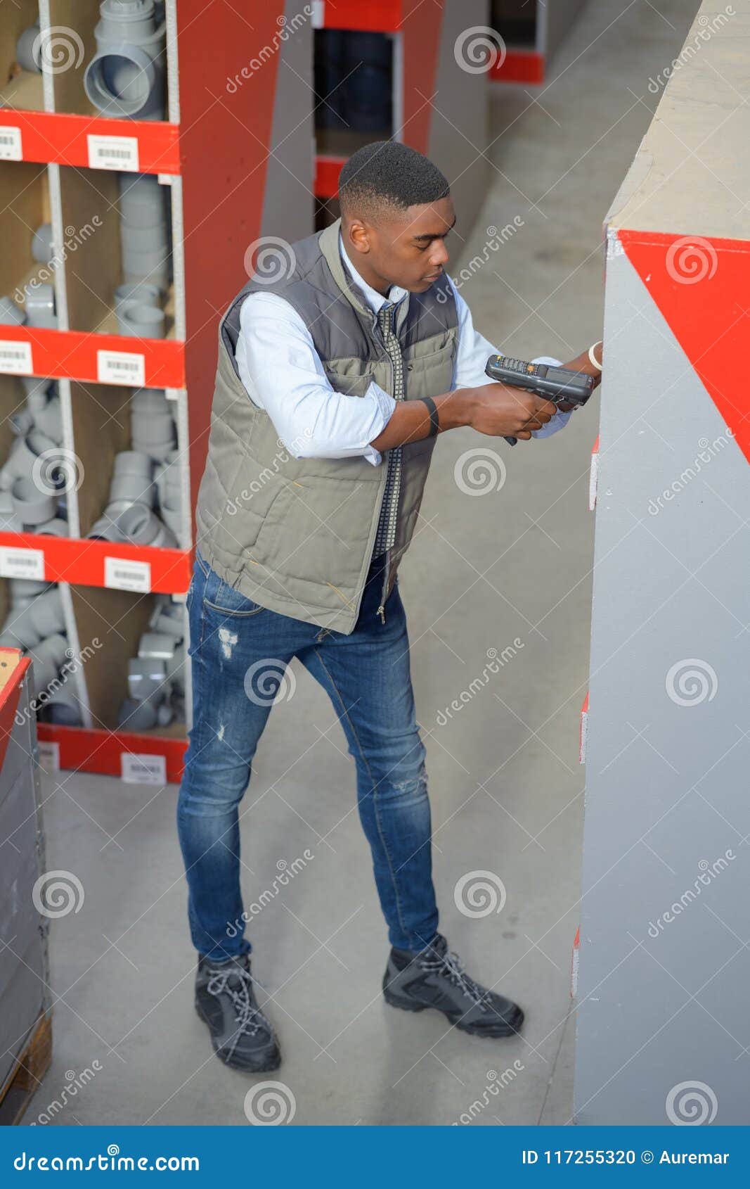 Worker in Distribution Warehouse with Handheld Barcode Scanner Stock ...