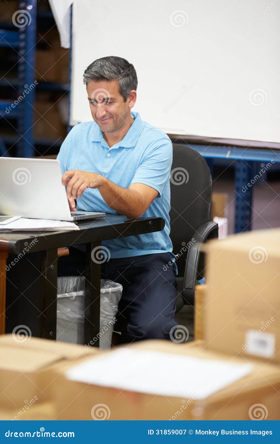 Worker in Distribution Warehouse Using Laptop Stock Image - Image of ...