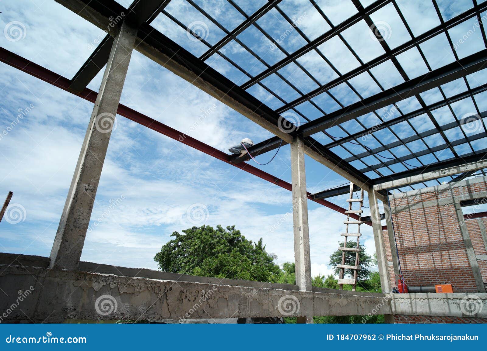 Worker Doing the Steelwork on the Structure of Metal Roof by Welding ...