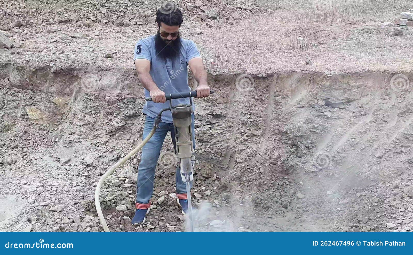 The Worker is Drilling a Hole in the Rock with a Jackhammer To Blast ...