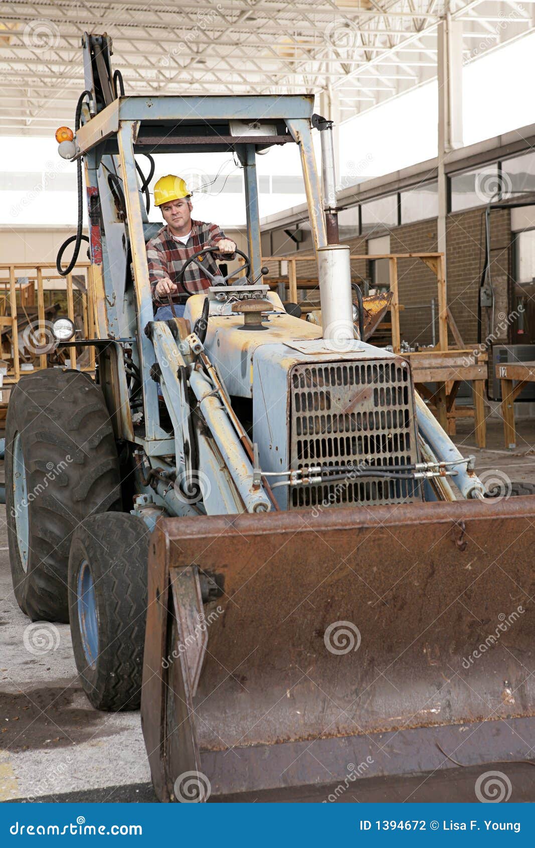 Worker Driving Backhoe stock photo. Image of jobsite, driver - 1394672