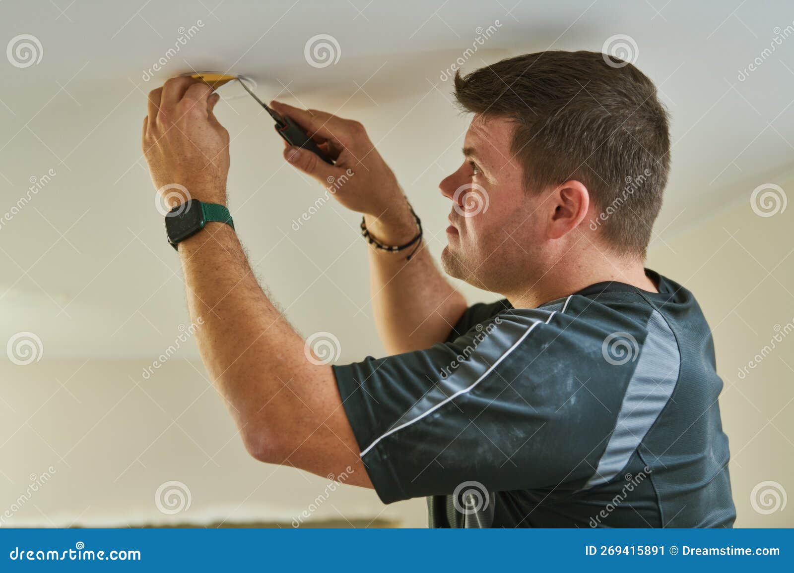 Electrician Installing Lamp on Stretch Ceiling Indoors Stock Image ...