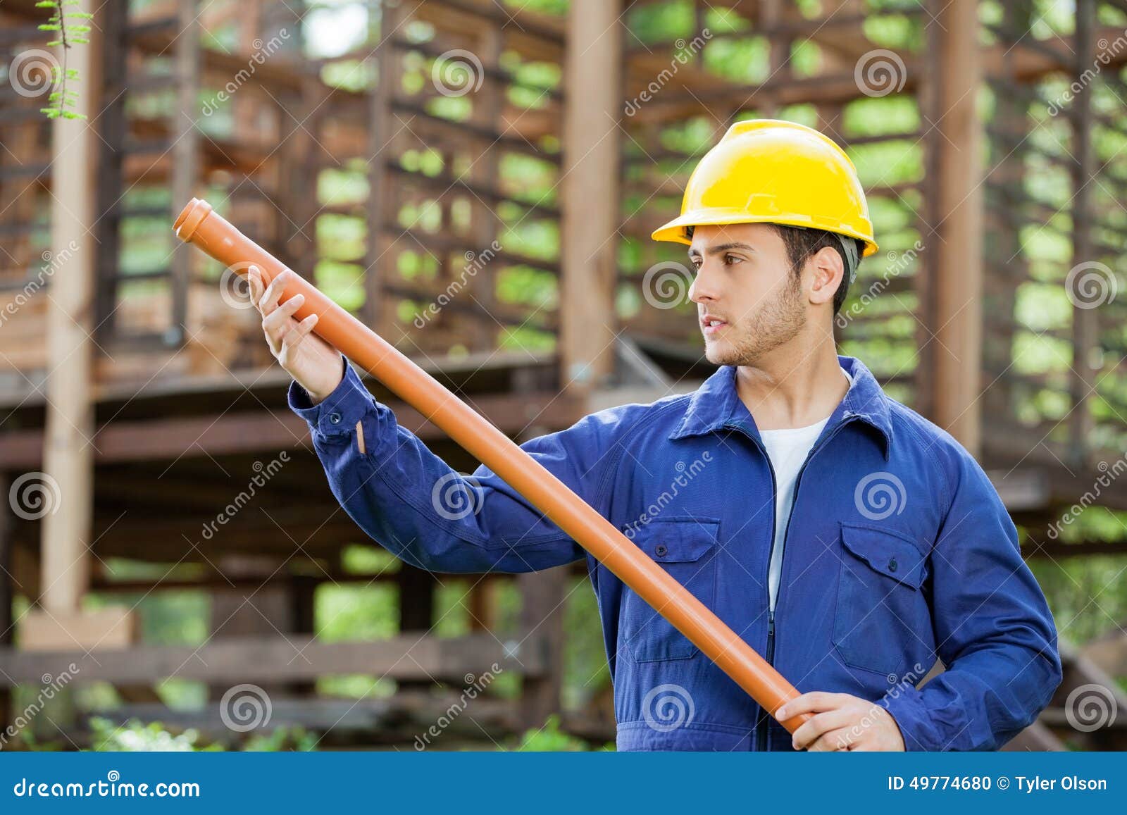 Worker Examining Pipe at Construction Site Stock Photo - Image of ...