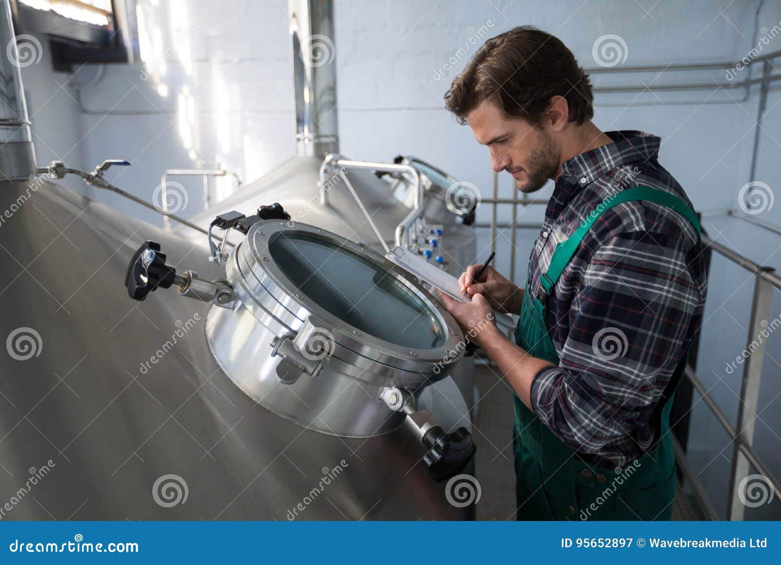 Worker Examining Storage Tanks Stock Image - Image of industry ...