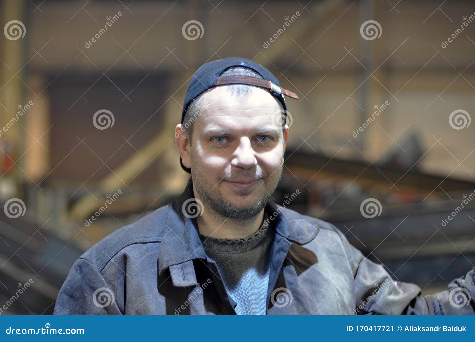 Worker at the Factory in the Background of the Factory Environment ...