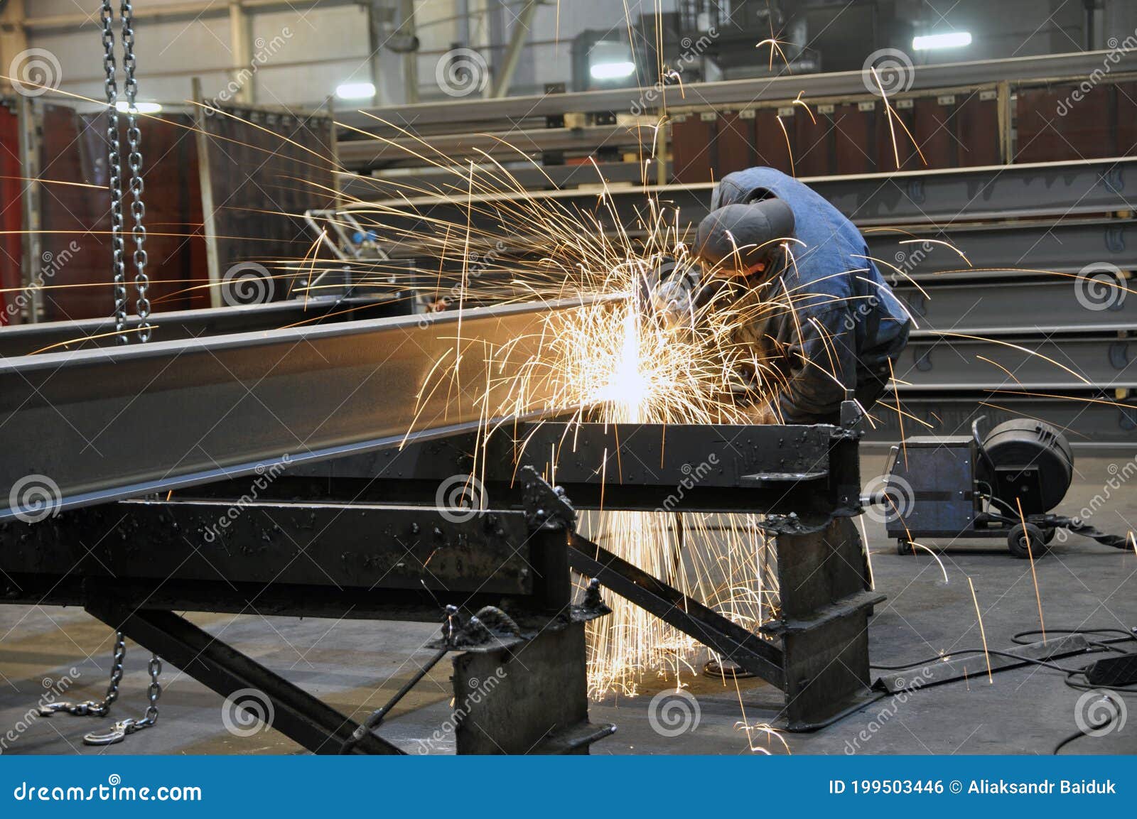 A Worker in a Factory is Cleaning the Steel Structure of an Angle ...