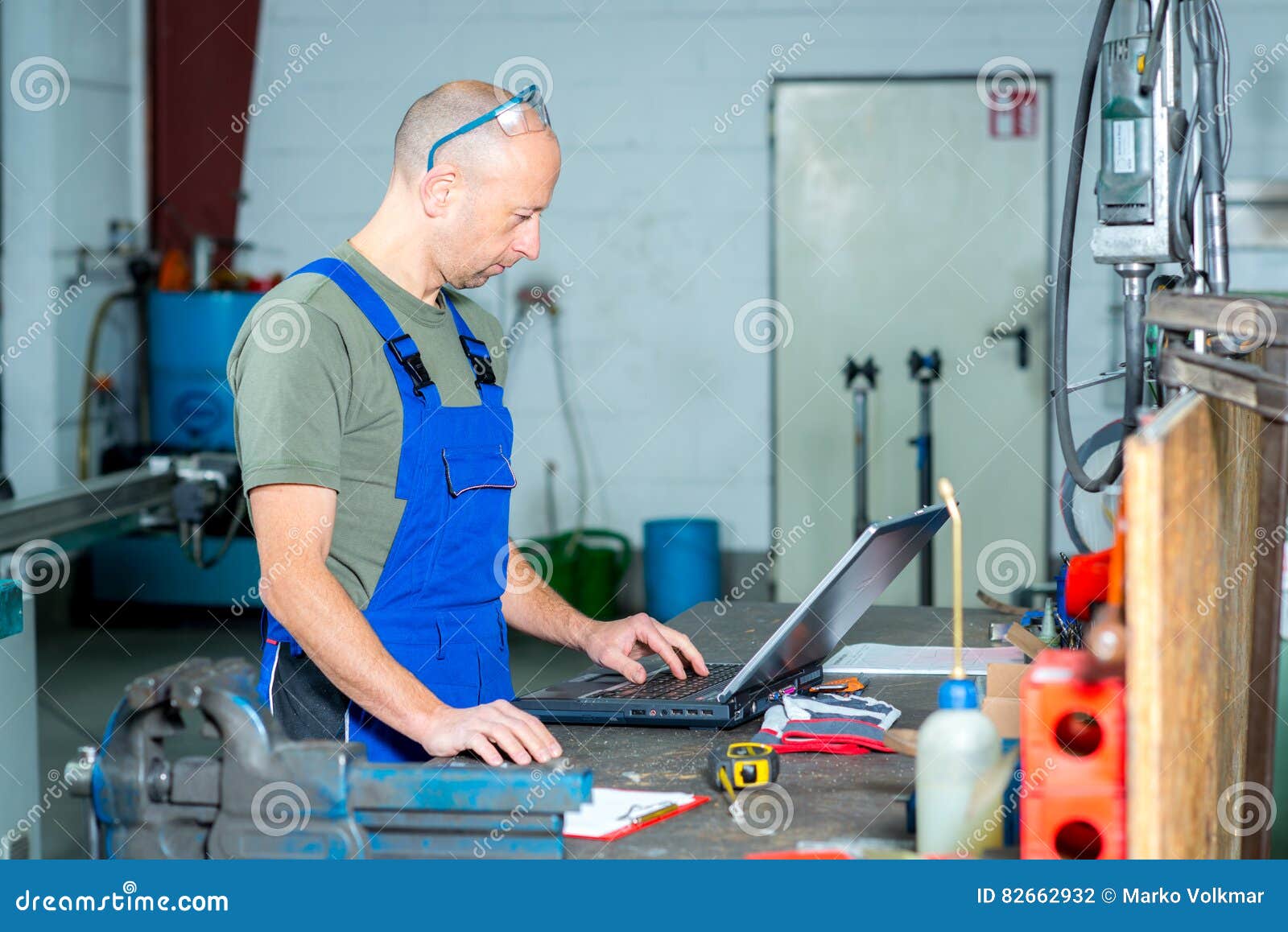 Worker in Factory on Work Bench with Computer Stock Photo - Image of ...