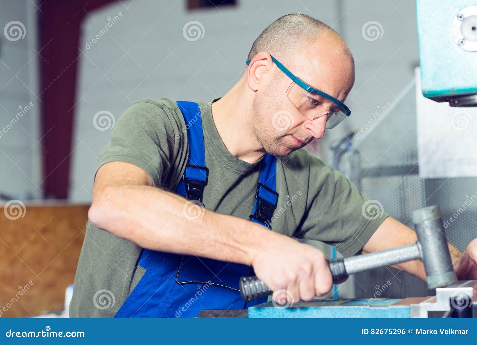 Worker in Factory on Work Bench with Hammer Stock Photo - Image of ...