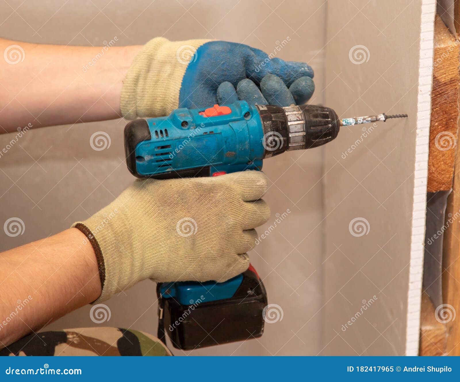 A Worker Fastens a Sheet of Drywall To the Wall Stock Image - Image of ...