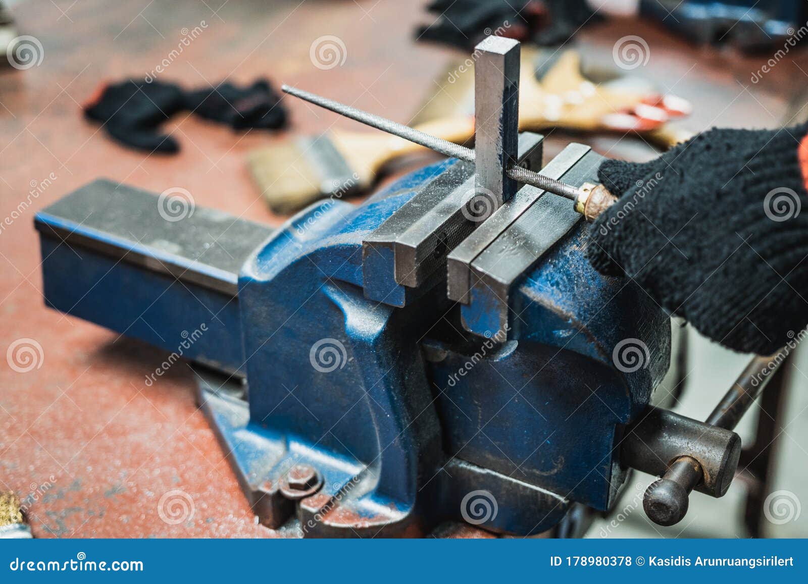 Worker File a Hole in a Piece of Metal in Workshop. Stock Photo - Image ...