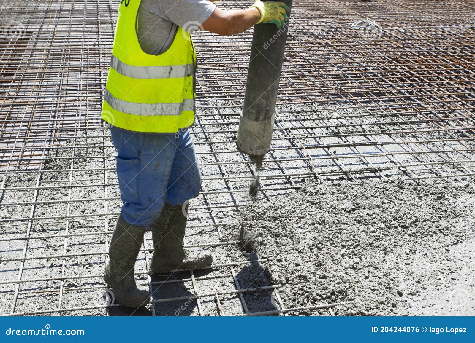 Worker Filling the Foundation Slab of a Building Under Construction ...