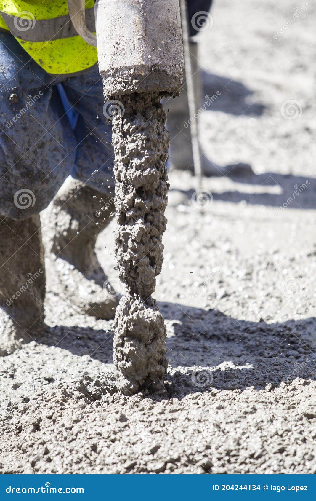 Worker Filling the Foundation Slab of a Building Under Construction ...