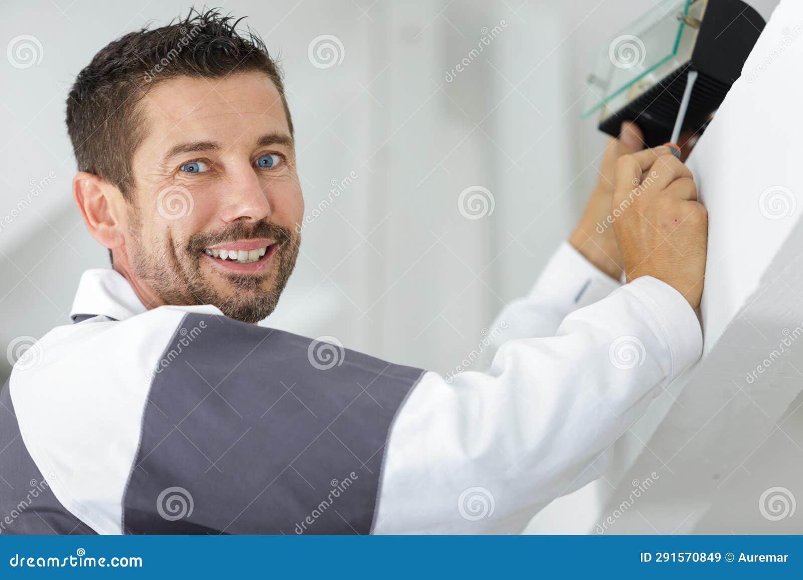 Worker fixing exit sign stock image. Image of exactitude - 291570849