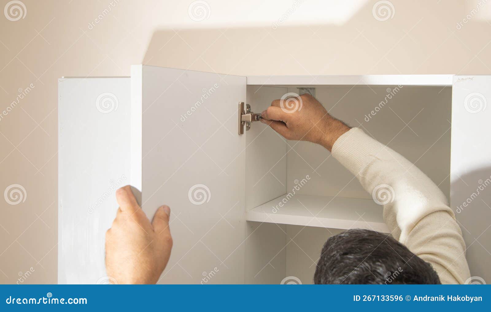 Worker Fixing Kitchen Cabinet Using Screwdriver Stock Photo - Image of ...