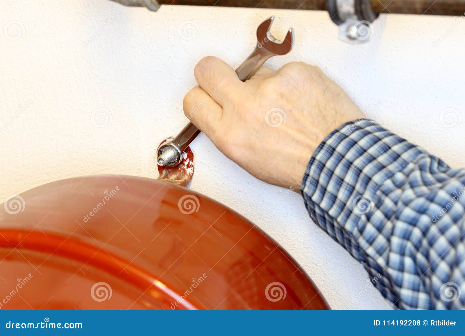 Worker is fixing a nut stock photo. Image of installing - 114192208