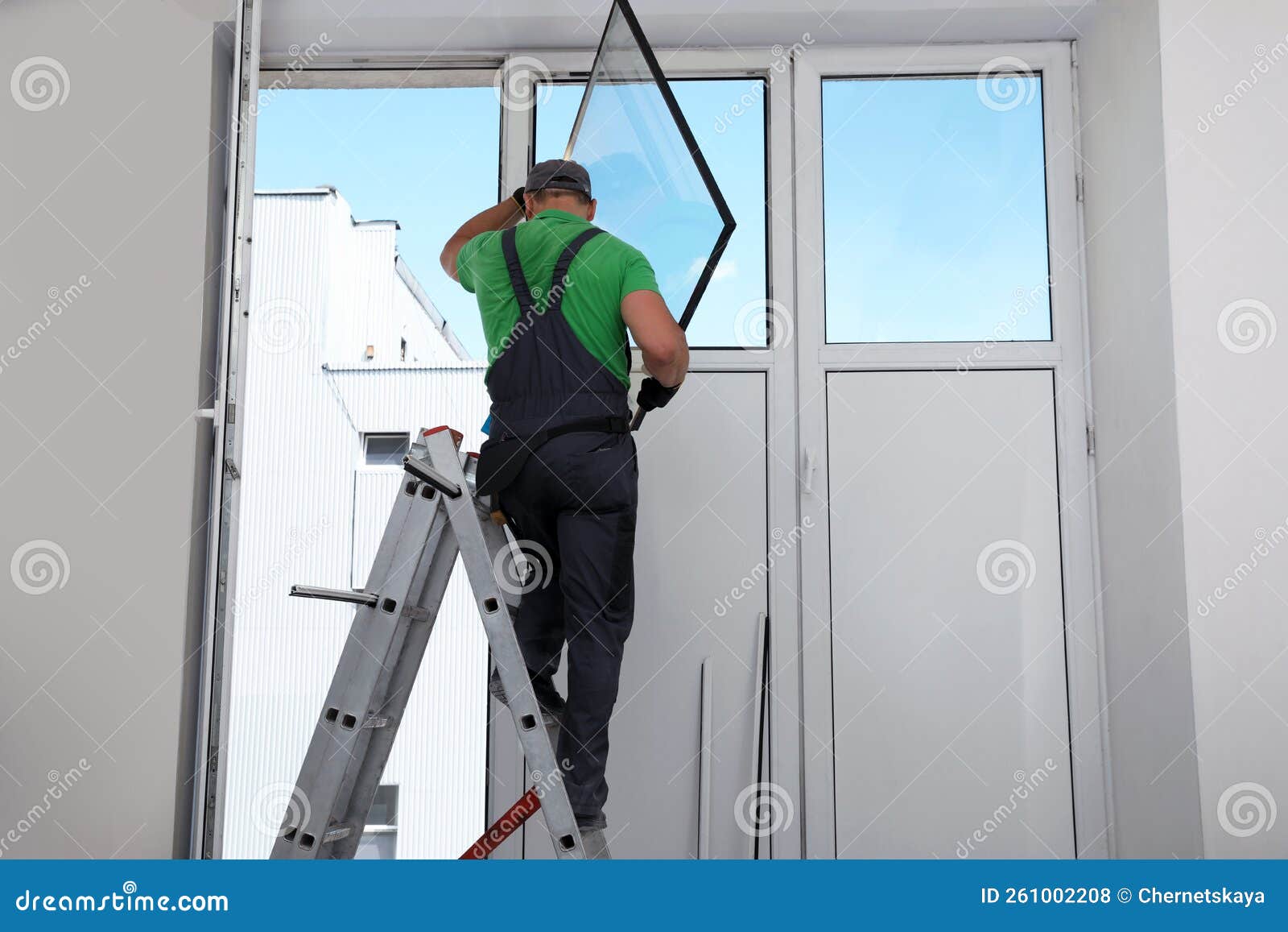 Worker on Folding Ladder Installing Window Indoors Stock Photo - Image ...