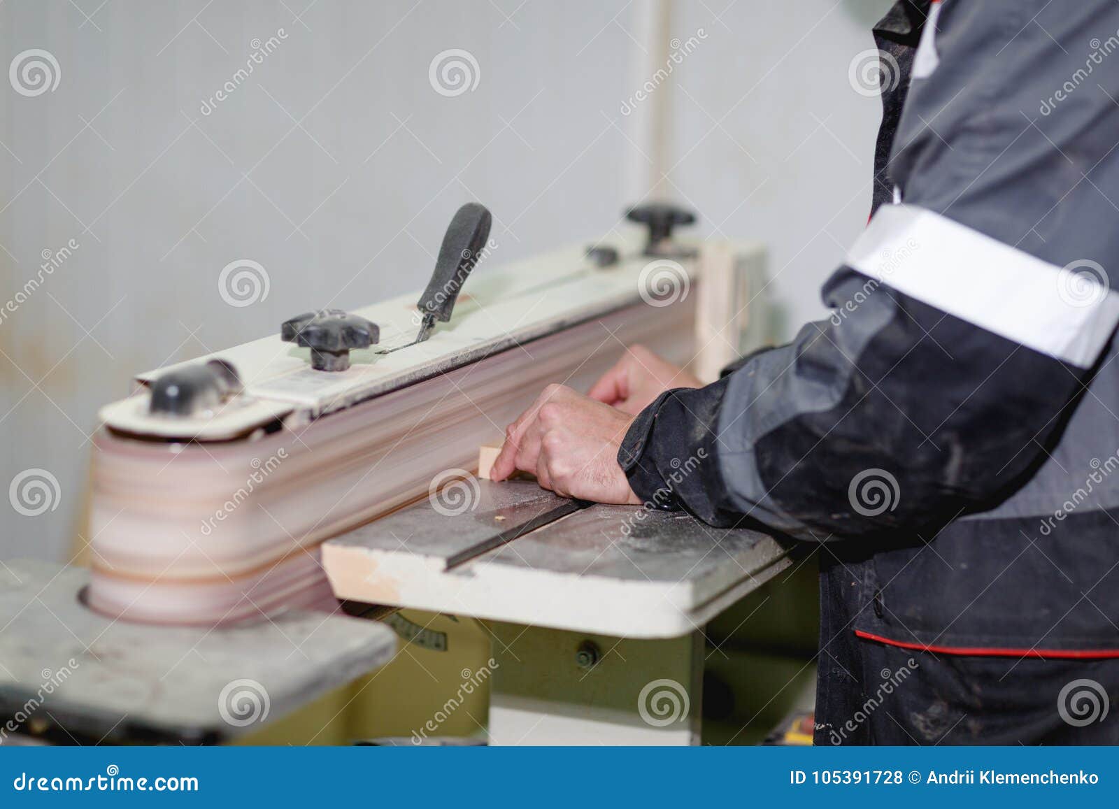 The Worker Grinds the Part on the Grinding Machine. Side View at an ...