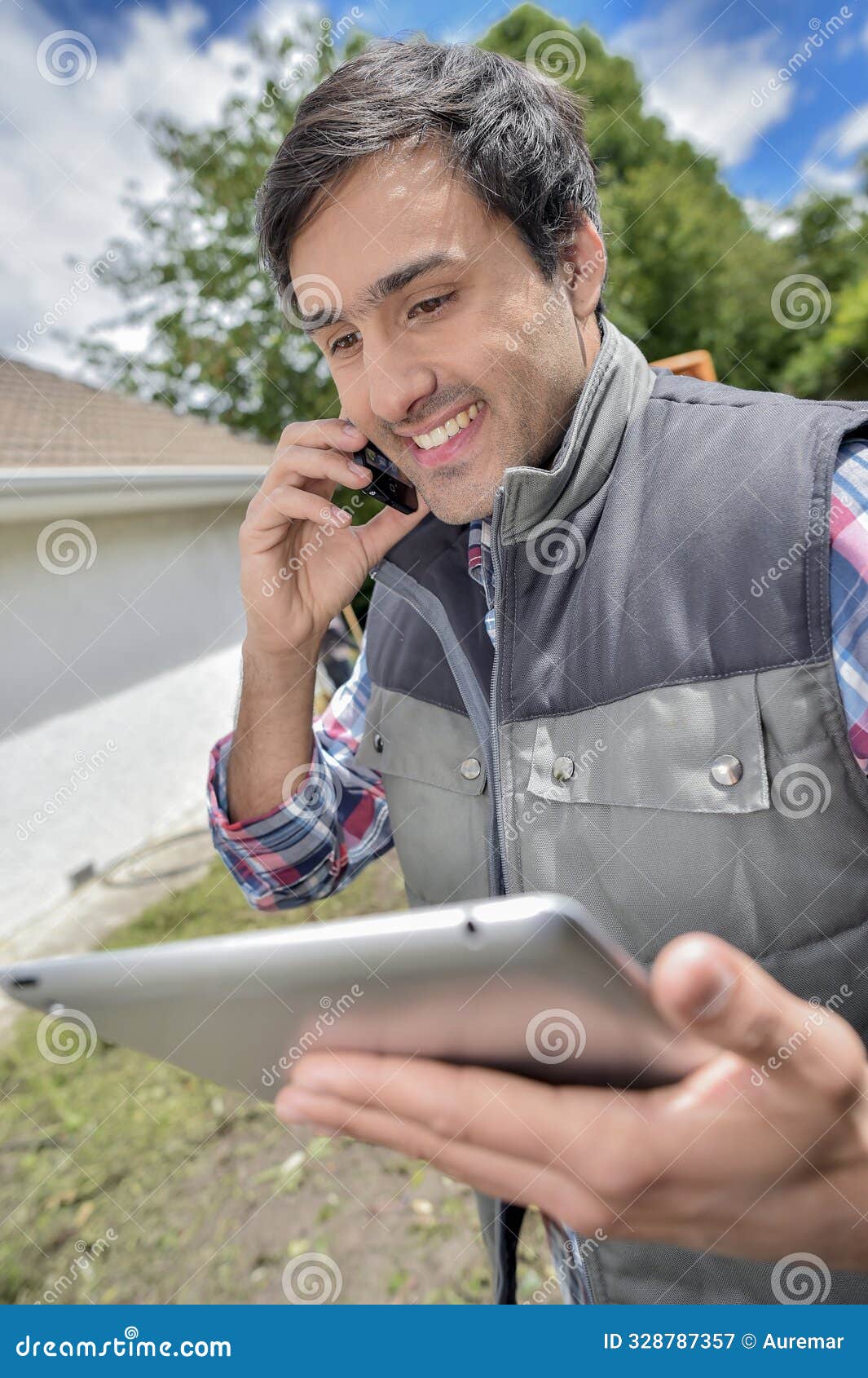 Worker in Garden on Telephone Holding Tablet Stock Image - Image of ...