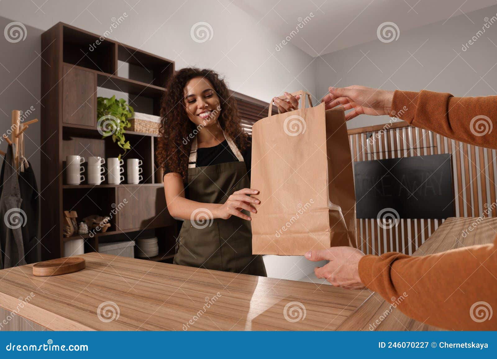 Worker Giving Paper Bag To Customer in Cafe Stock Image - Image of ...