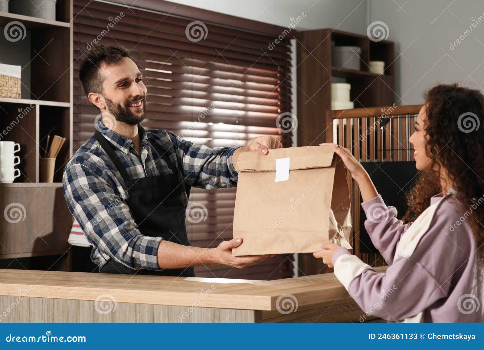 Worker Giving Paper Bag To Customer in Cafe Stock Image - Image of male ...