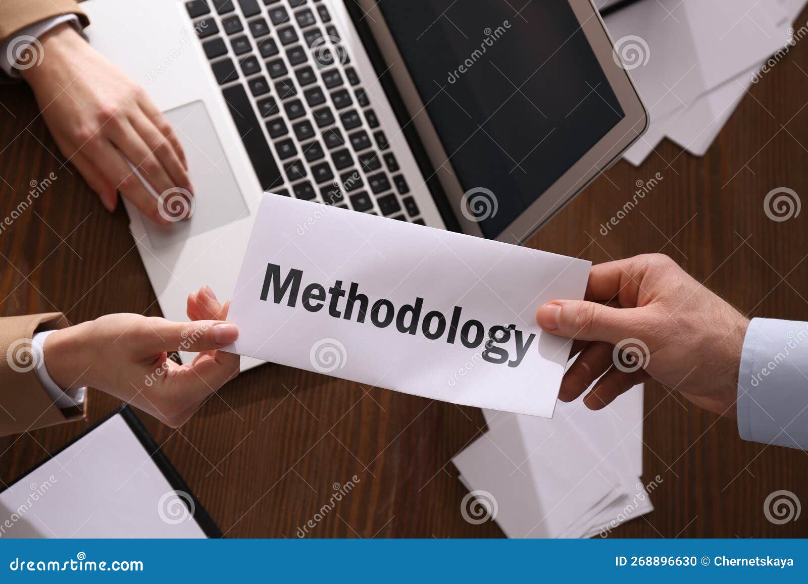 Worker Giving Paper with Word Methodology To Man in Office, Top View ...