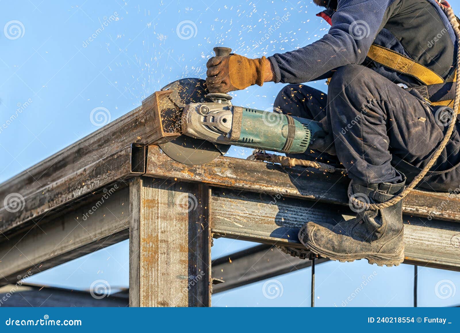 The Worker is Grinding Steel Box Profile with Hand Grinding Machine in ...