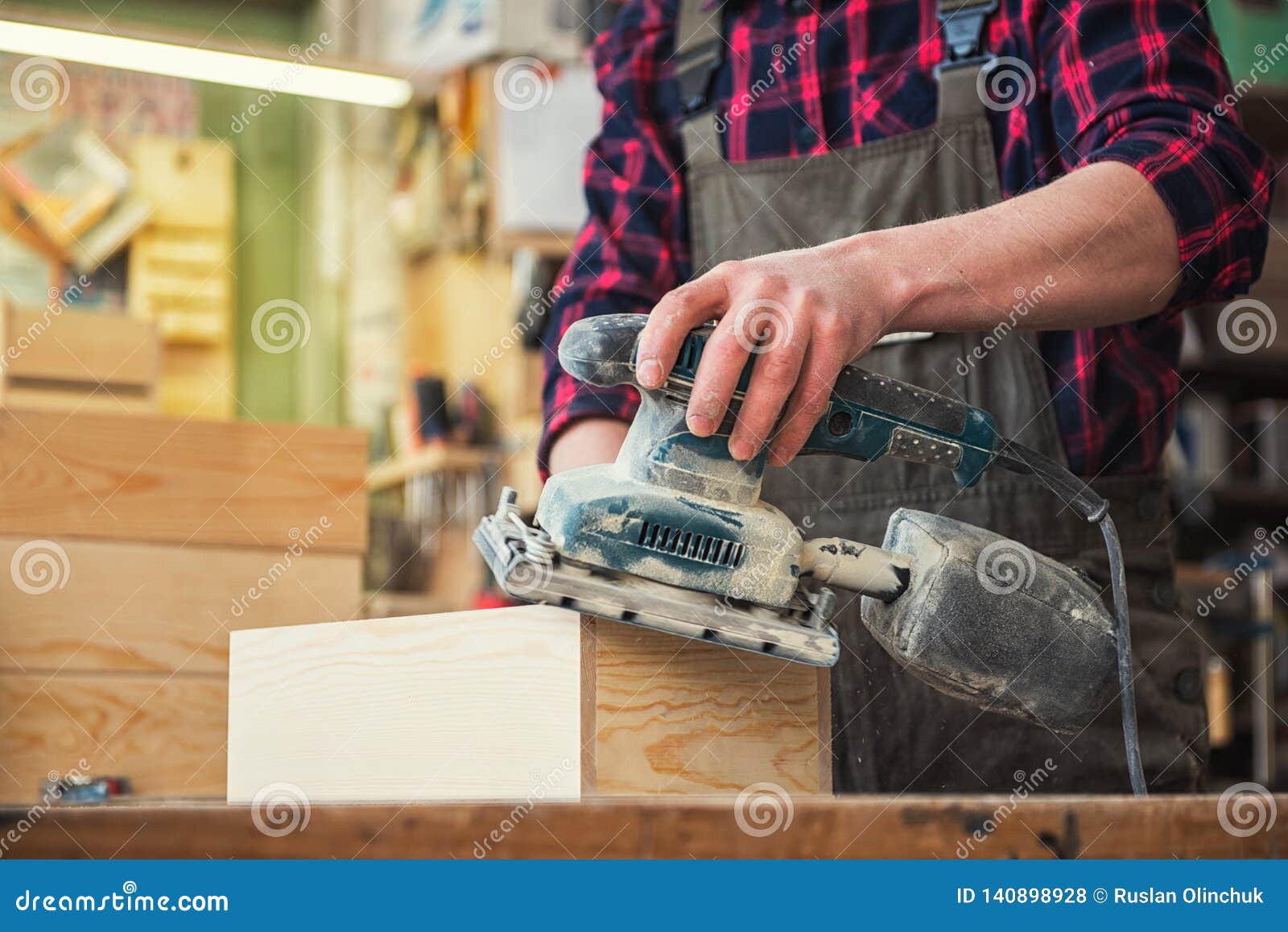Worker grinds the wood box stock photo. Image of holding - 140898928