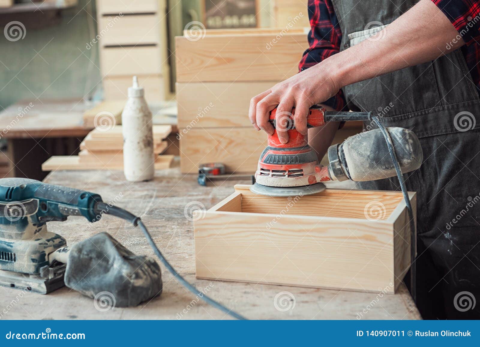 Worker grinds the wood box stock image. Image of improvement - 140907011