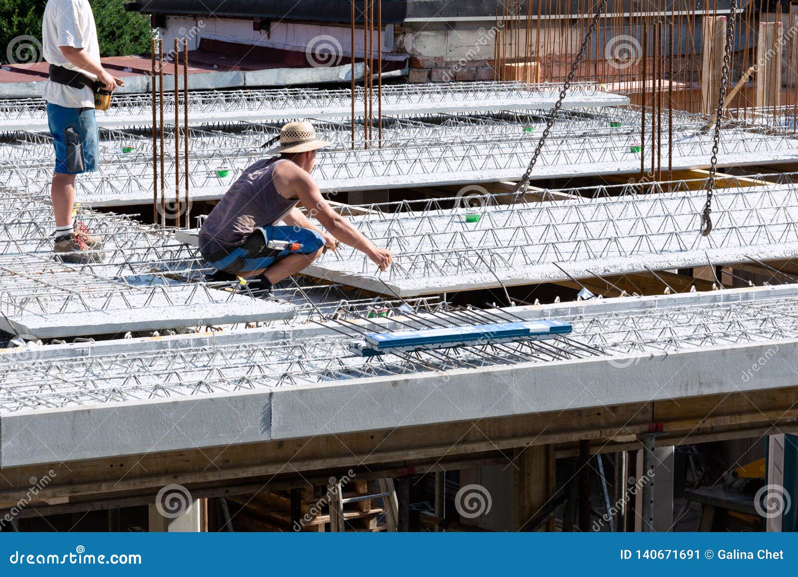 Worker Guides the Descending Concrete Slab at the Construction Site ...