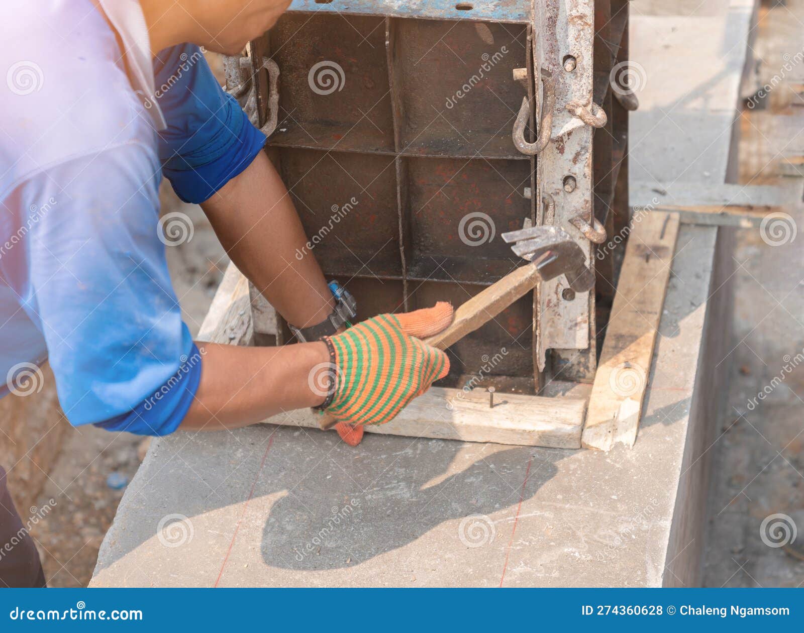 Worker Hammering a Nail into a Plank, Formwork Installation Stock Photo ...