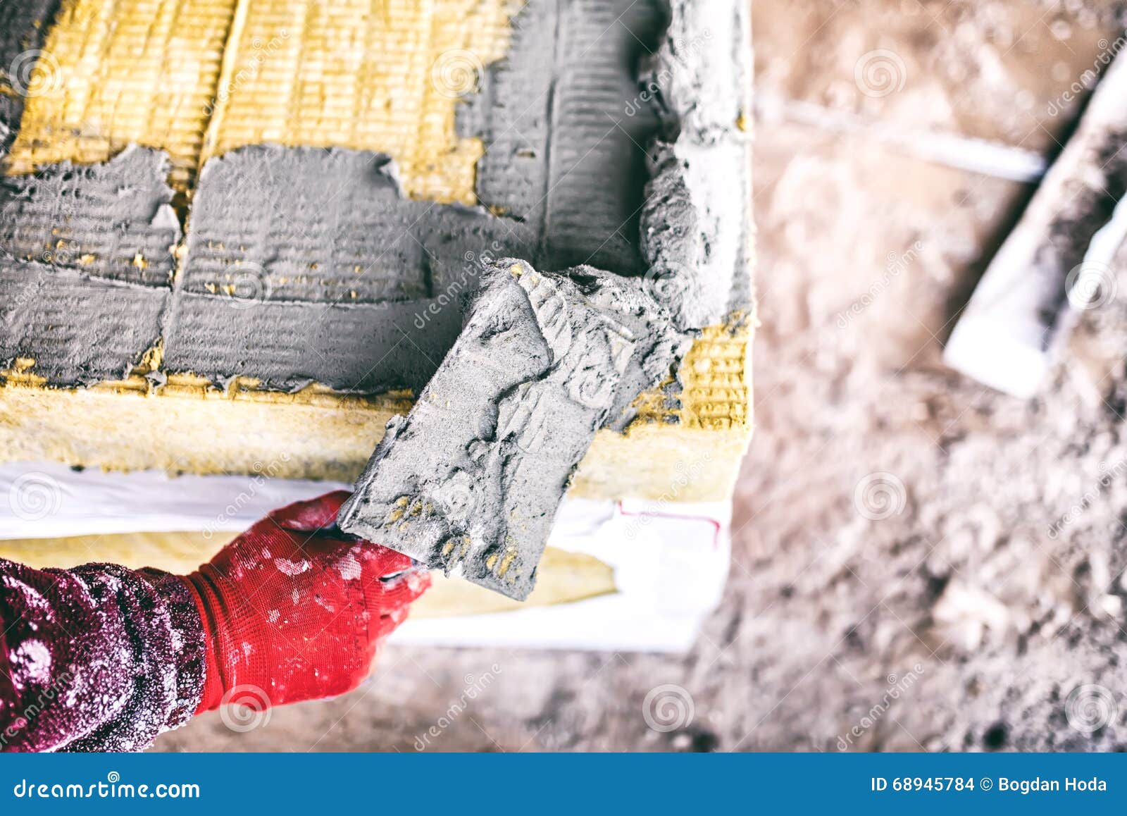 Worker Hand on Industrial Construction Site Using a Trowel and Applying ...