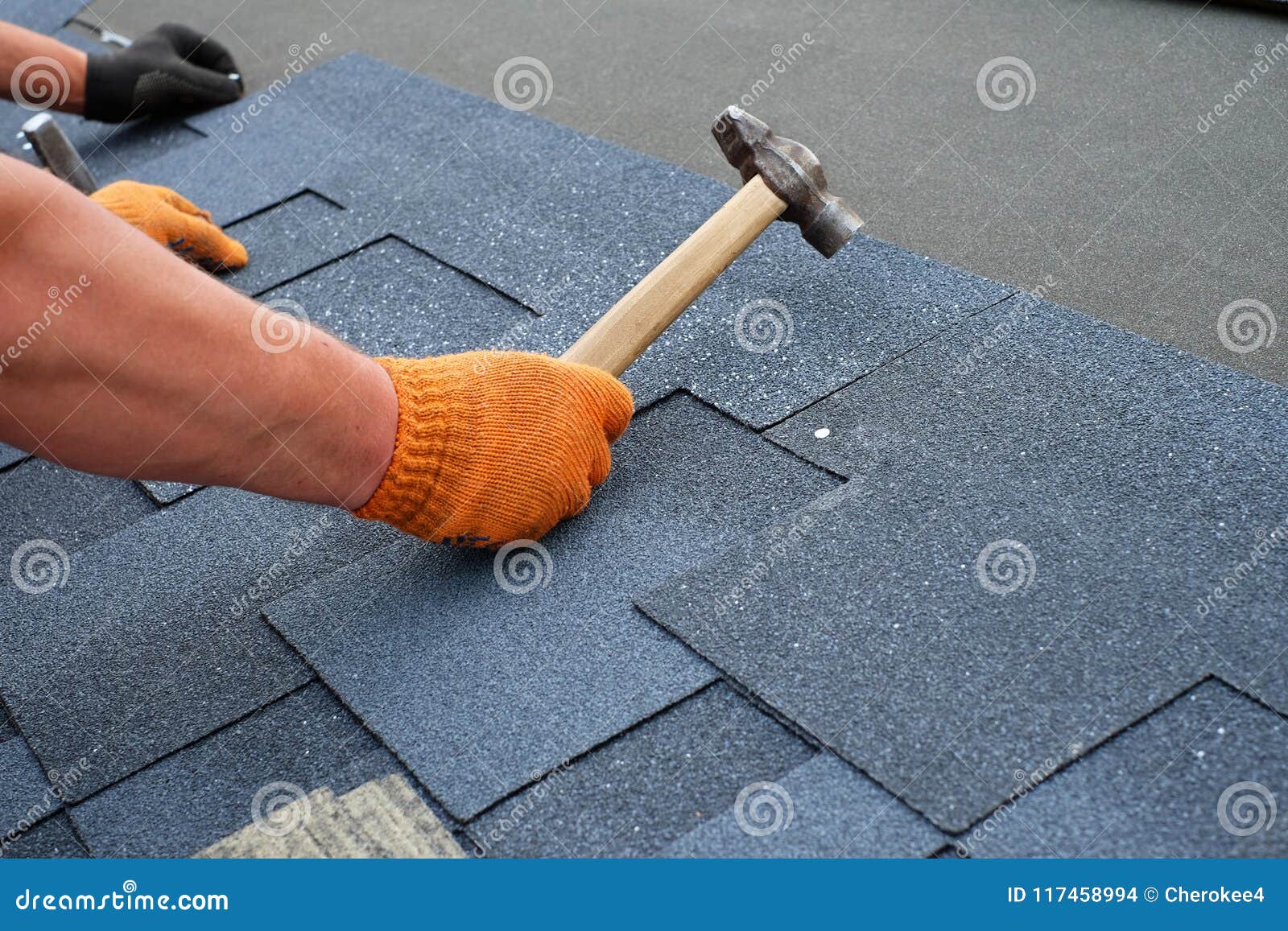 Worker Hands Installing Bitumen Roof Shingles Using Hammer in Nails ...