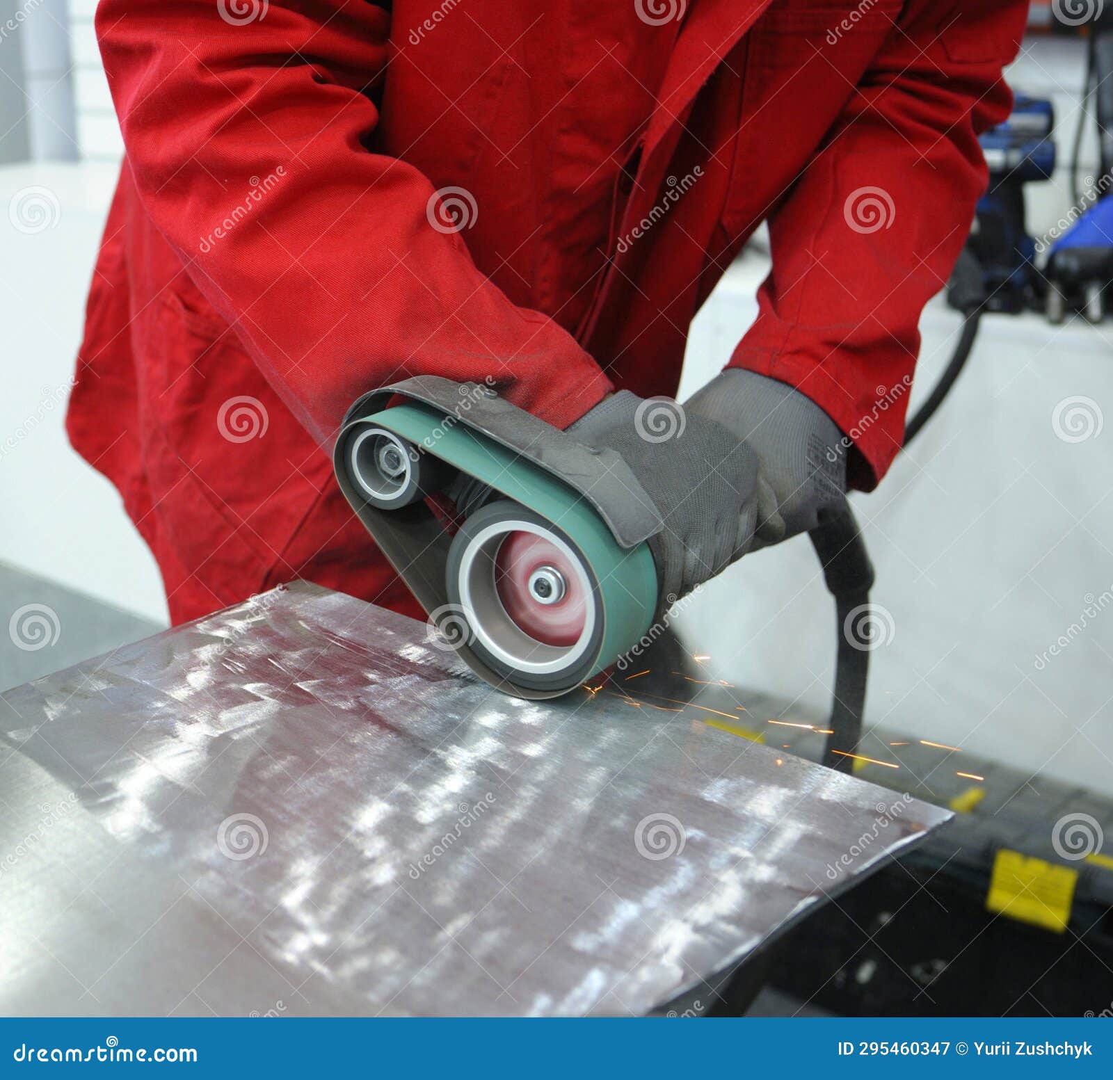 Worker Hands Sanding Metal Sheet by the Hand Held Belt Sender Stock ...