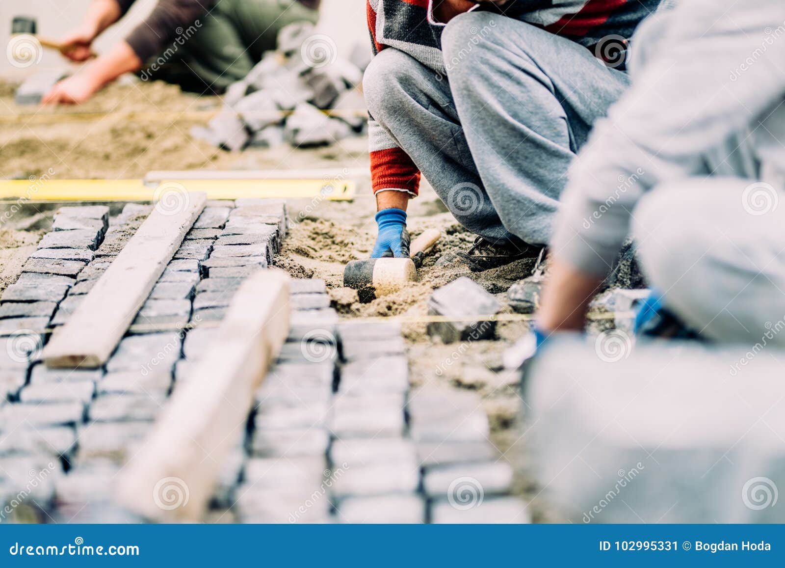 Worker, Handyman and Construction Worker Installing Cobblestone ...