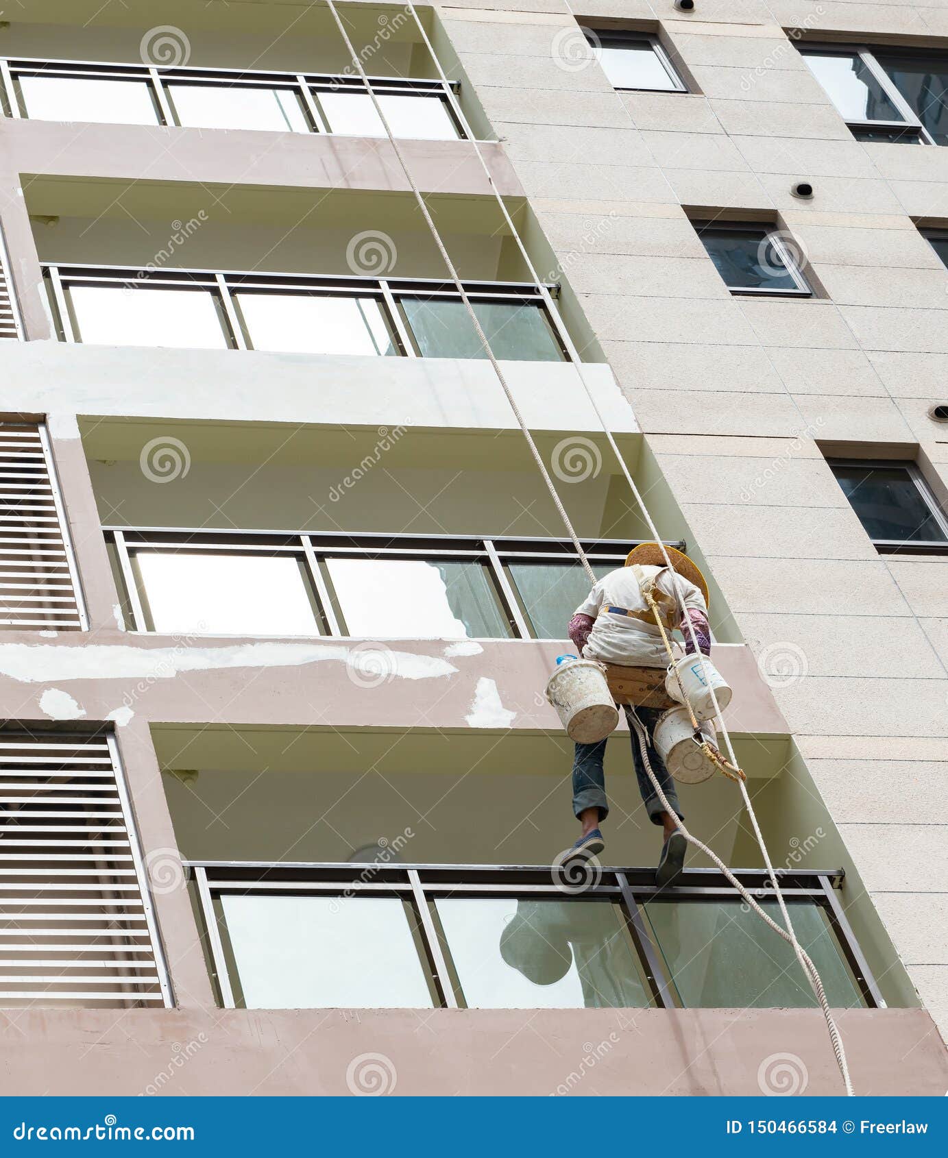 Worker Hanging with Ropes & Painting the Oustside of a Highrise ...