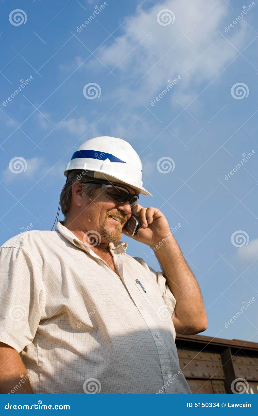 Worker with Hard Hat on Phone Stock Photo - Image of masculine, outdoor ...