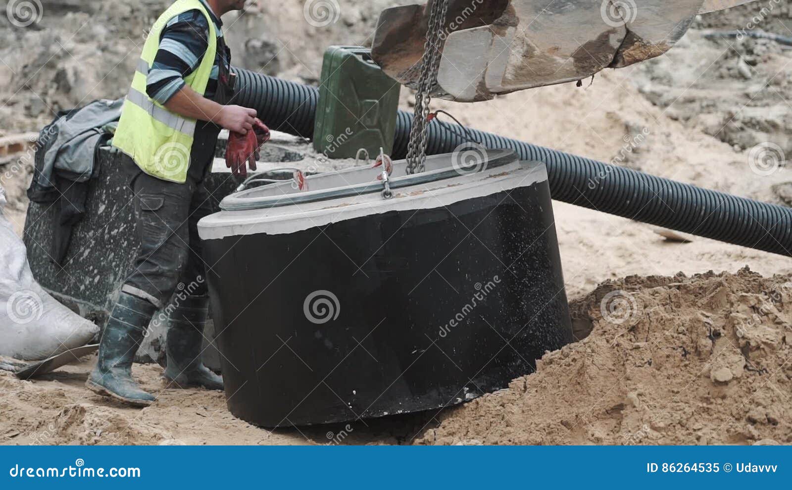 Worker in Hard Hat Pulling Concrete Manhole Ring Off Chains on ...
