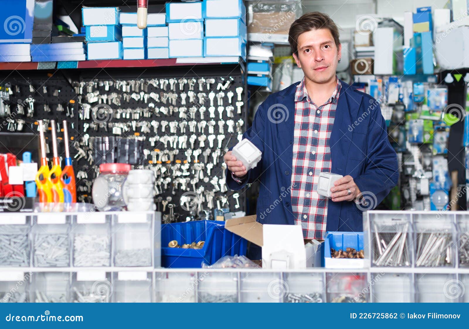 Worker in Hardware Store is Trading Sockets Stock Photo - Image of ...