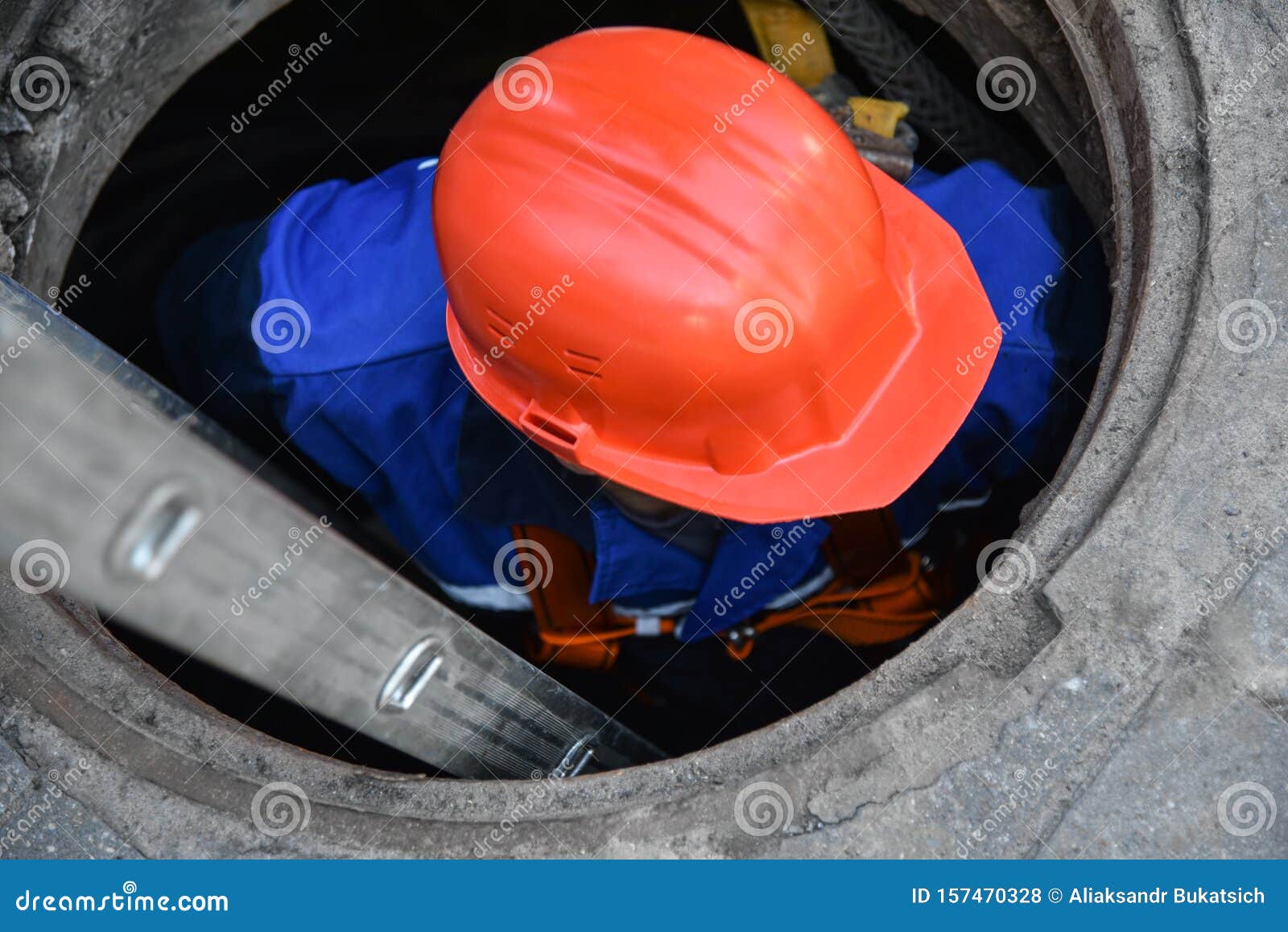 Worker in a Helmet Descends into a Cable Well Stock Photo - Image of ...