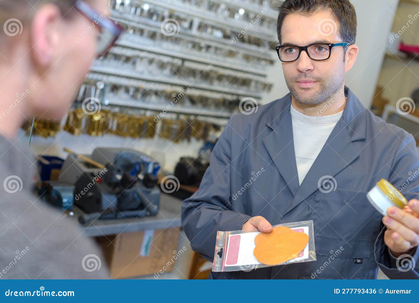 Worker Helping Female Client To Choose Product in Leather Workshop ...