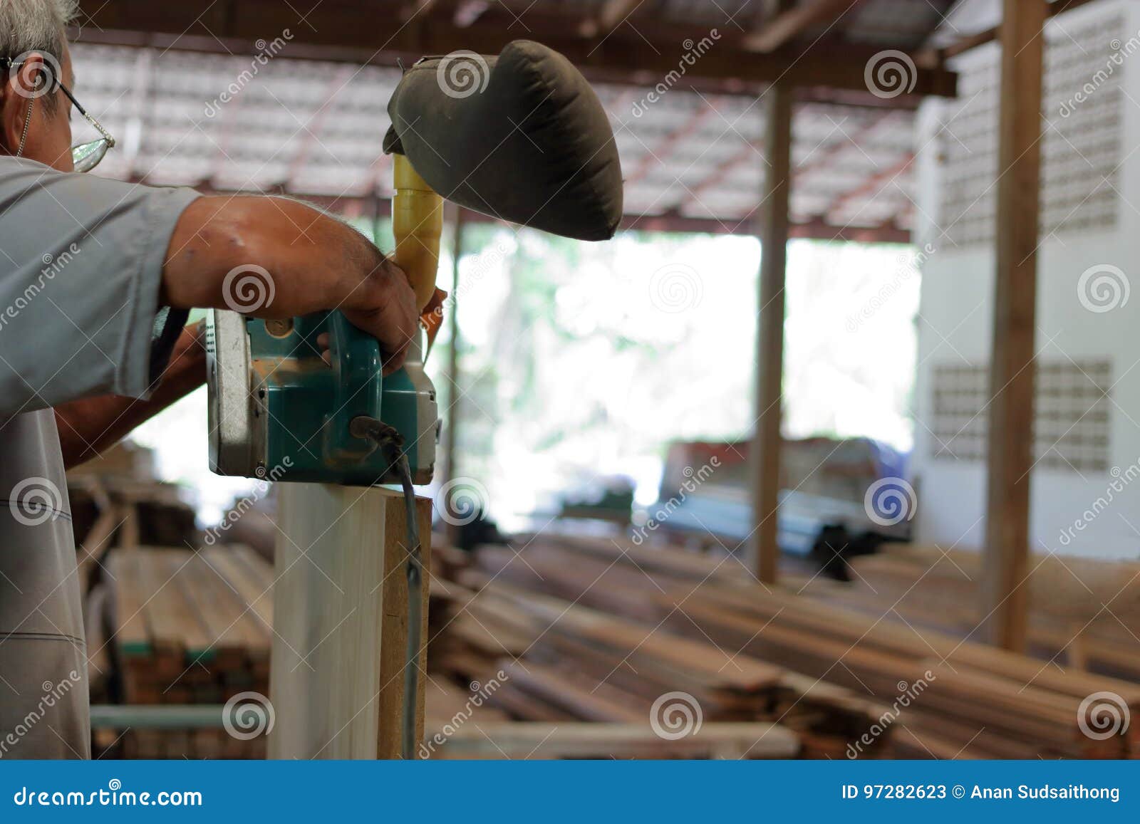 Worker Holding a Belt Sander on Vertical of Wooden Board in Carpentry ...