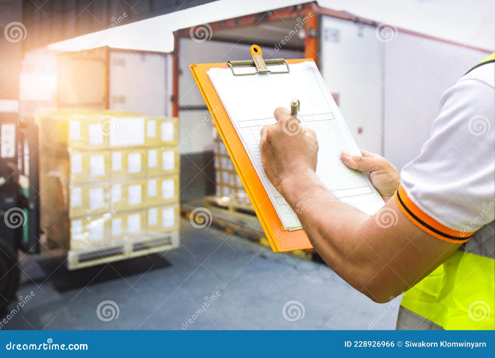 Worker Holding Clipboard is Control Loading Package Box into Cargo ...