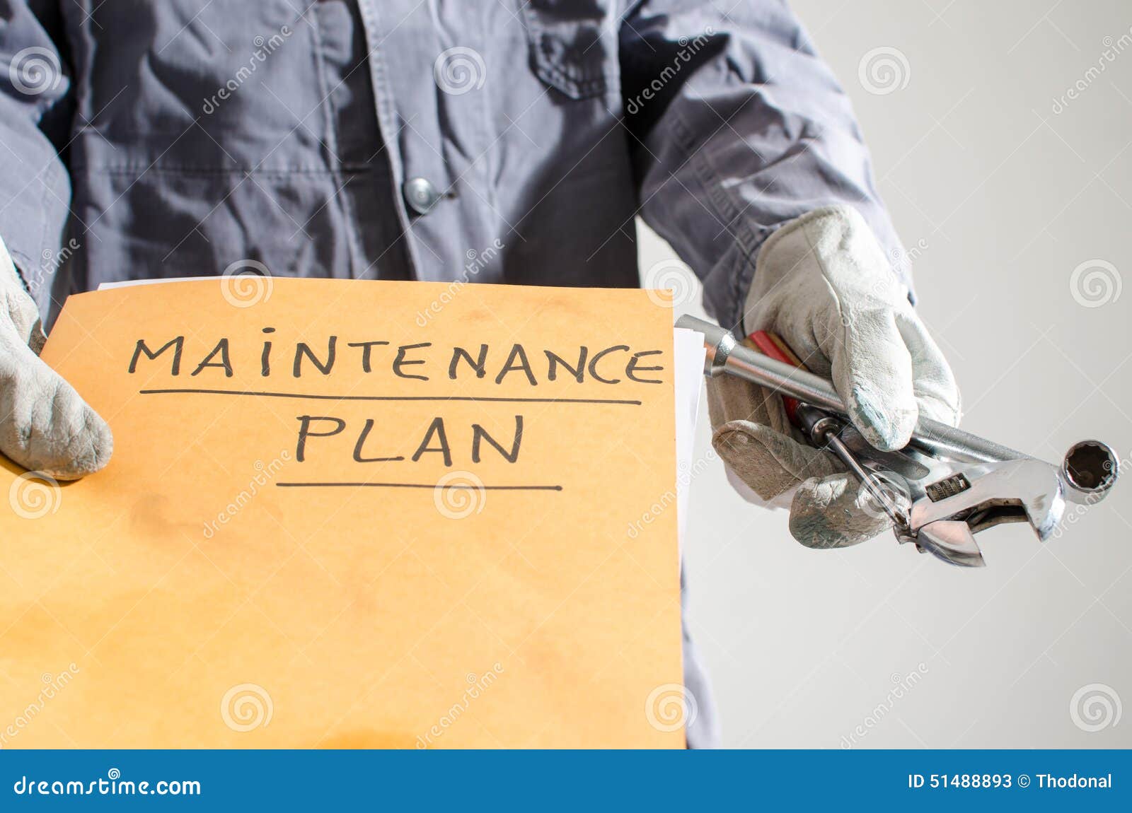Worker Holding a Folder of Maintenance Plan and Tools Stock Image ...