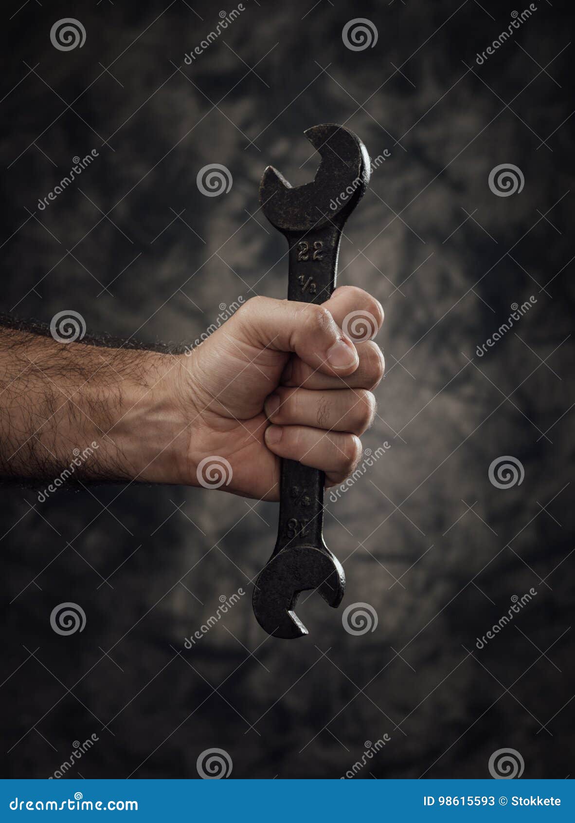 Worker holding a spanner stock image. Image of service - 98615593