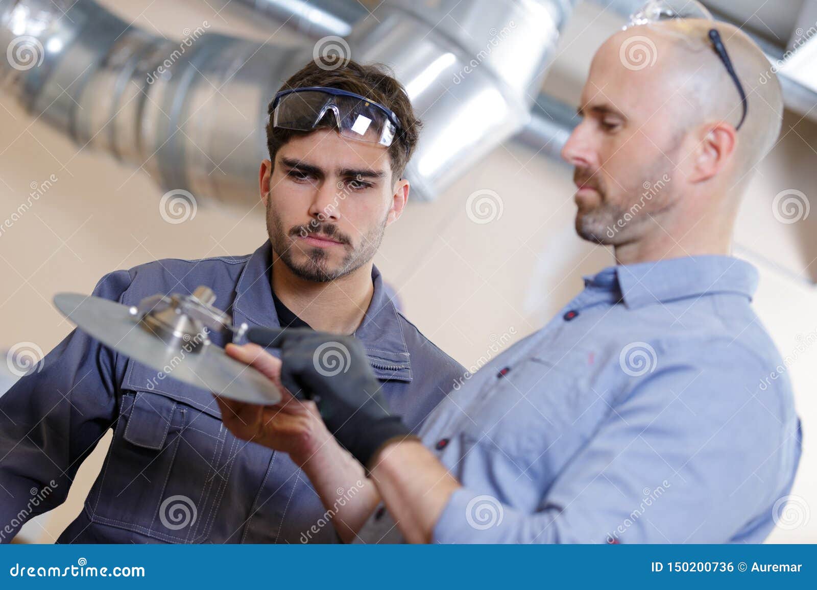 Worker Holding and Studying Circular Mechanism Stock Photo - Image of ...